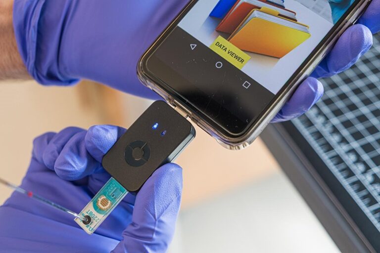 Microfluidic Smartphone Dongle Detects COVID-19